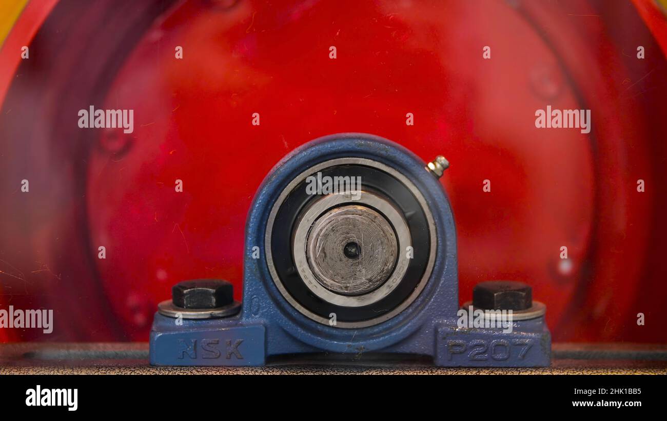 Close-up of rotating red cylinder. Media. Rotating industrial drum is ...