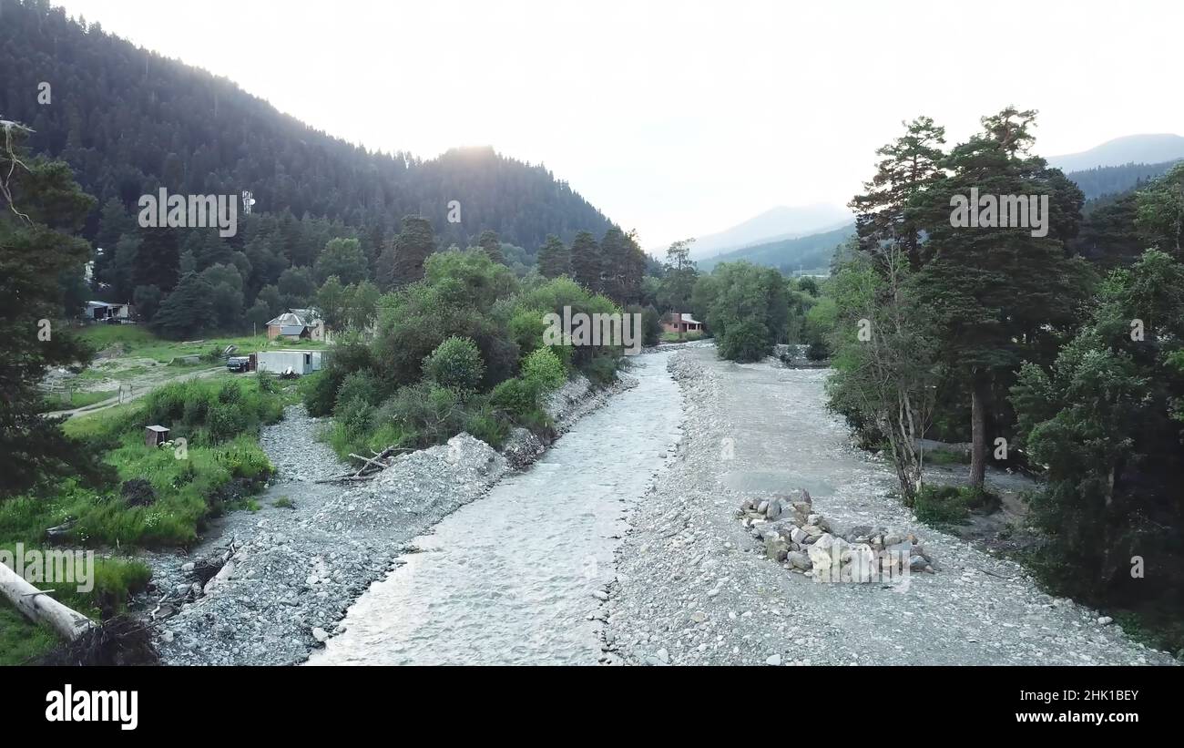 Top view of the river in a small settlement. Mountain countryside small ...