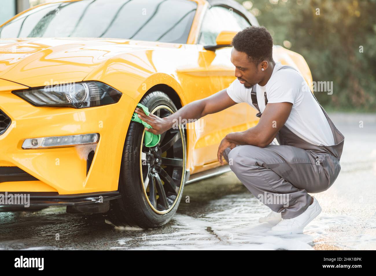 Car wash service outdoors. Car wash self-service concept. Handsome ...