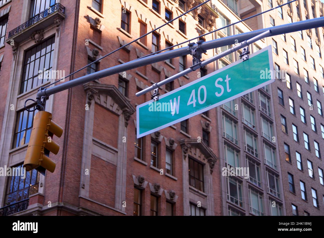 Green big West 40th Street sign hanging on a arch pole in the streets ...