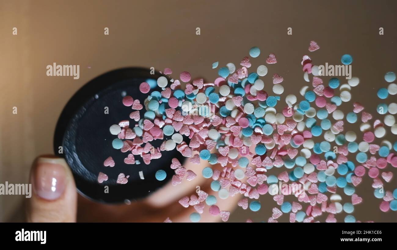 Throwing sweet sugar pastry decoration on transparent flat surface ...