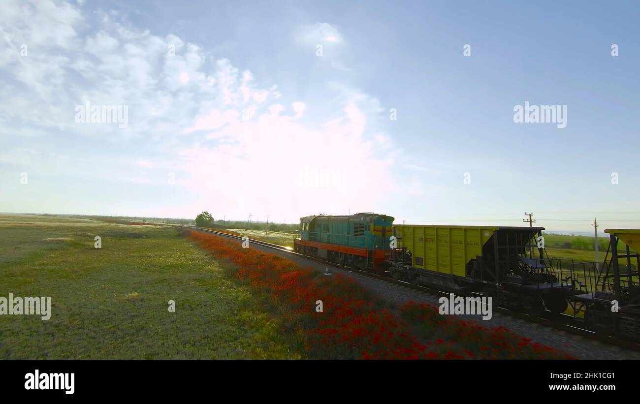 Top view of summer landscape with moving train. Shot. Drone flies with ...