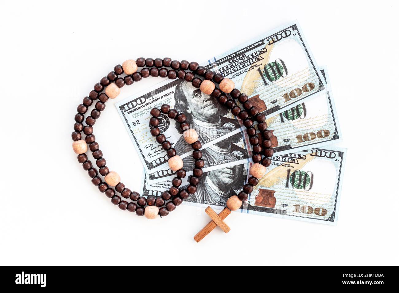 Dollars with religion rosary and wooden cross. Religion concept Stock ...