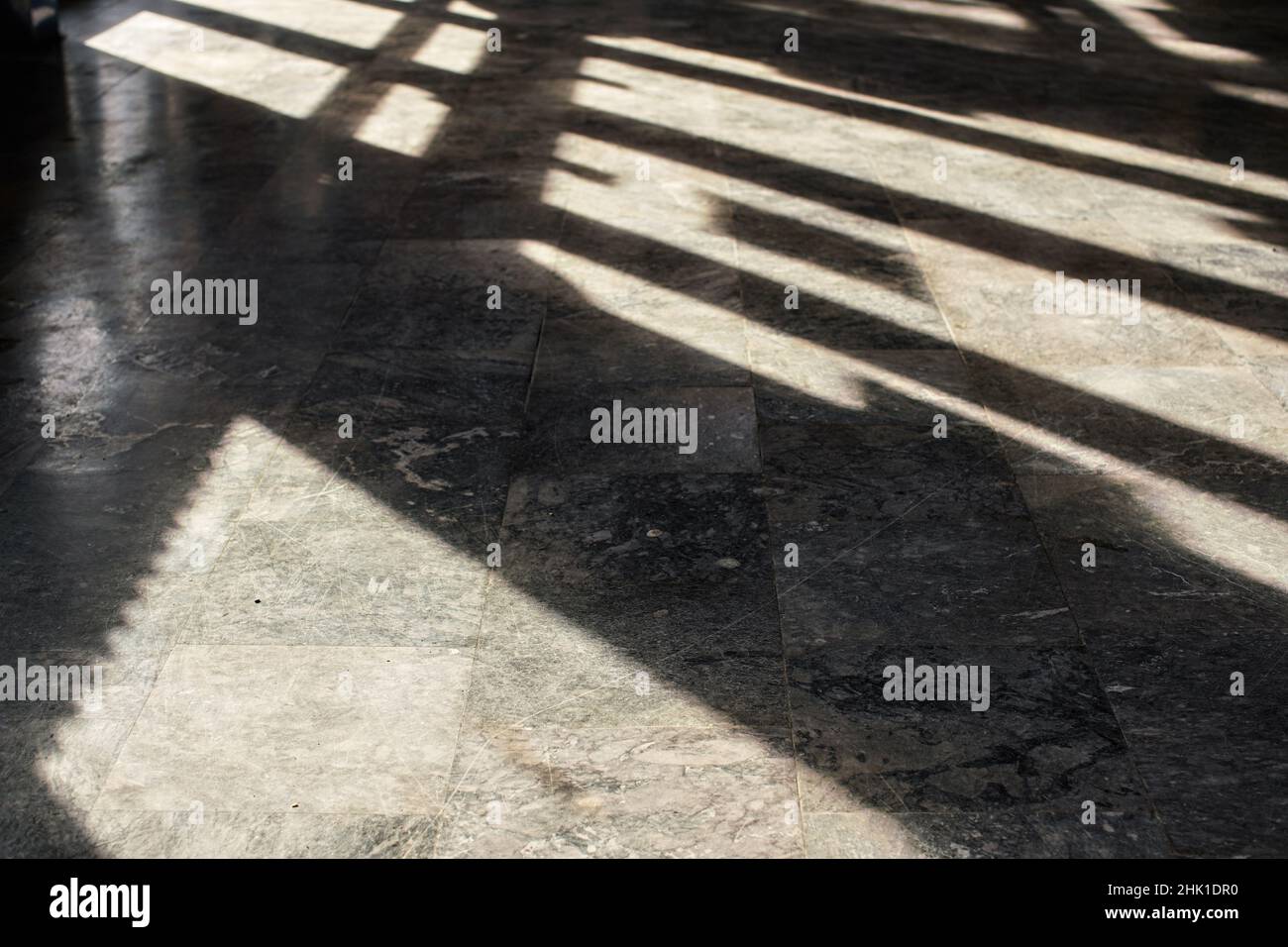 Shadows from window frames on stone indoor floor, shallow depth of ...