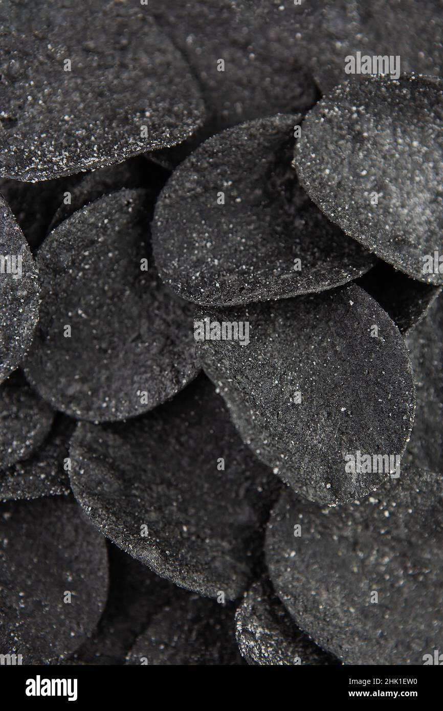 Selective focus. Macro chips. Spices and salt on black chips. Black ...