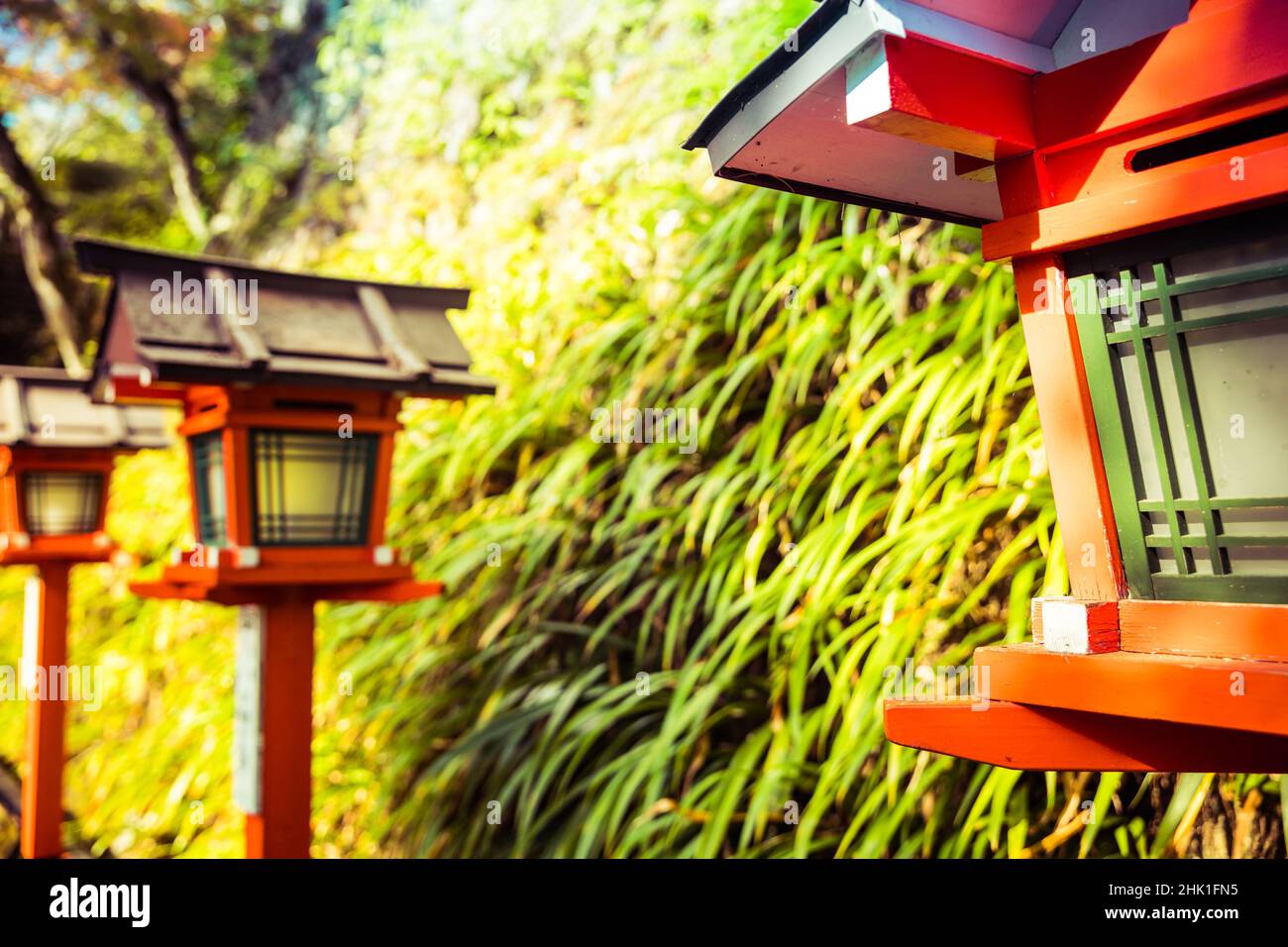 A traditional Japanese style wooden lamp post with hints of fall color ...