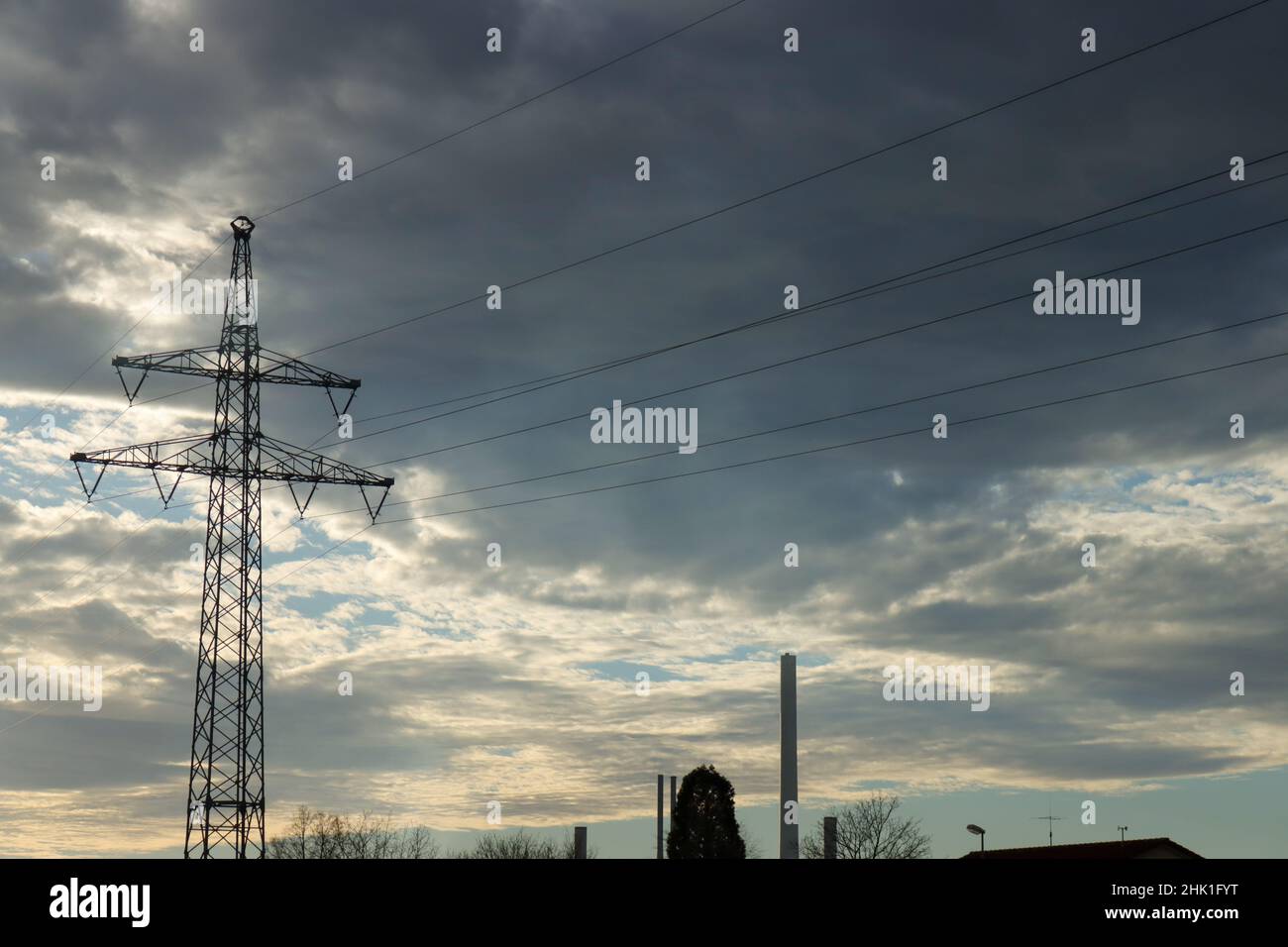 Shot of electricity and signal tower with cloudy sky Stock Photo - Alamy