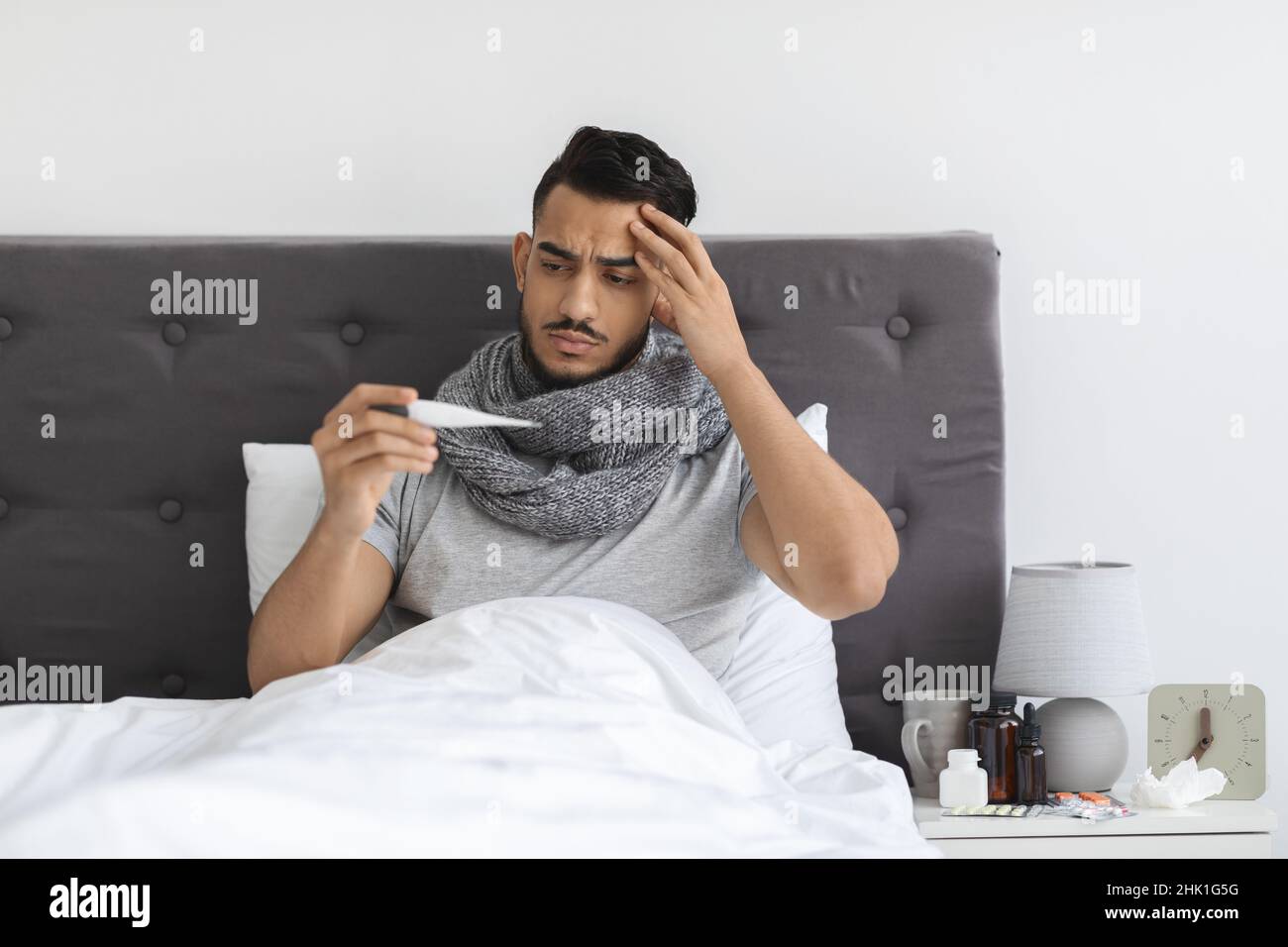 Sick person with thermometer in bed hi-res stock photography and images ...
