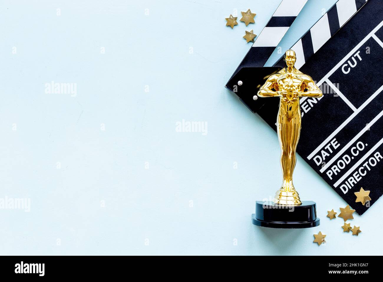 Movie clapper board with golden film award statue Stock Photo - Alamy