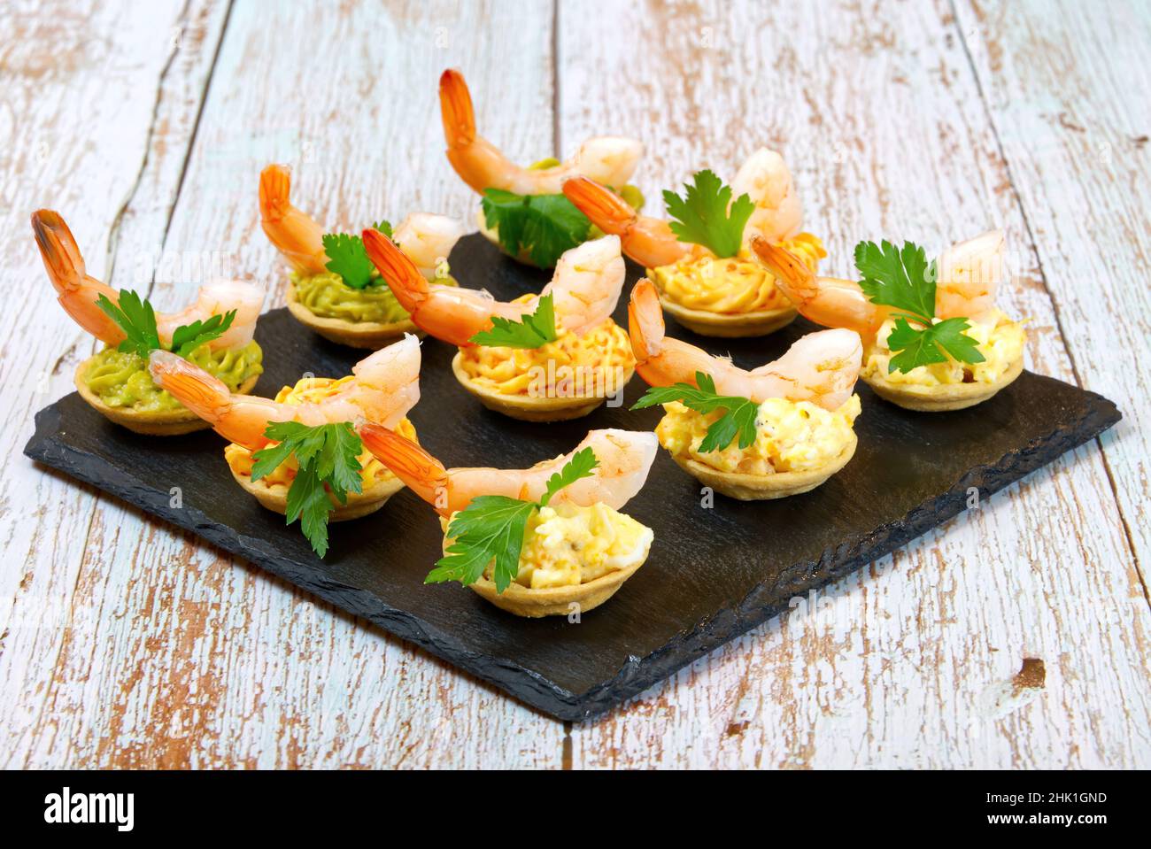 canape with cream cheese and shrimps on black stone plate Stock Photo ...