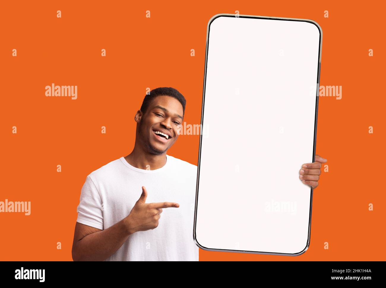 Black guy pointing at white empty smartphone screen Stock Photo - Alamy