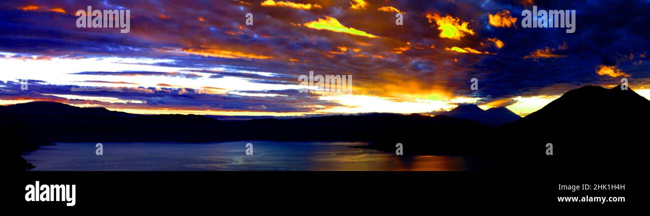 Panorama of mountains and small towns at sunrise surrounding Lake ...