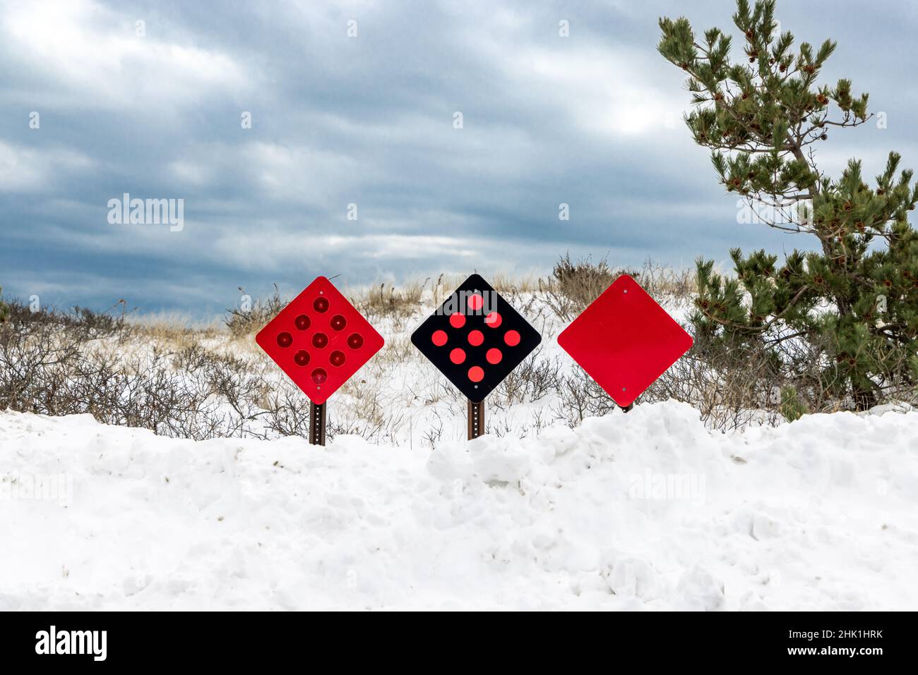 Three bright street signs partially buried in snow Stock Photo - Alamy