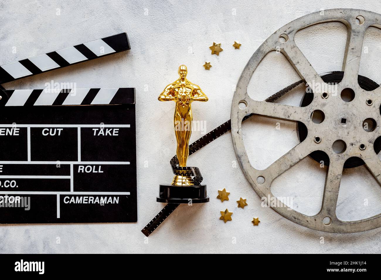 Golden movie award statue with film reel video tape and clapper board ...