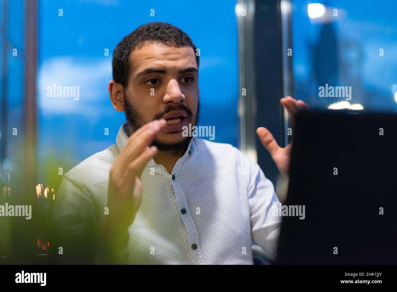 Virtual meeting with many people together. African-American young guy ...