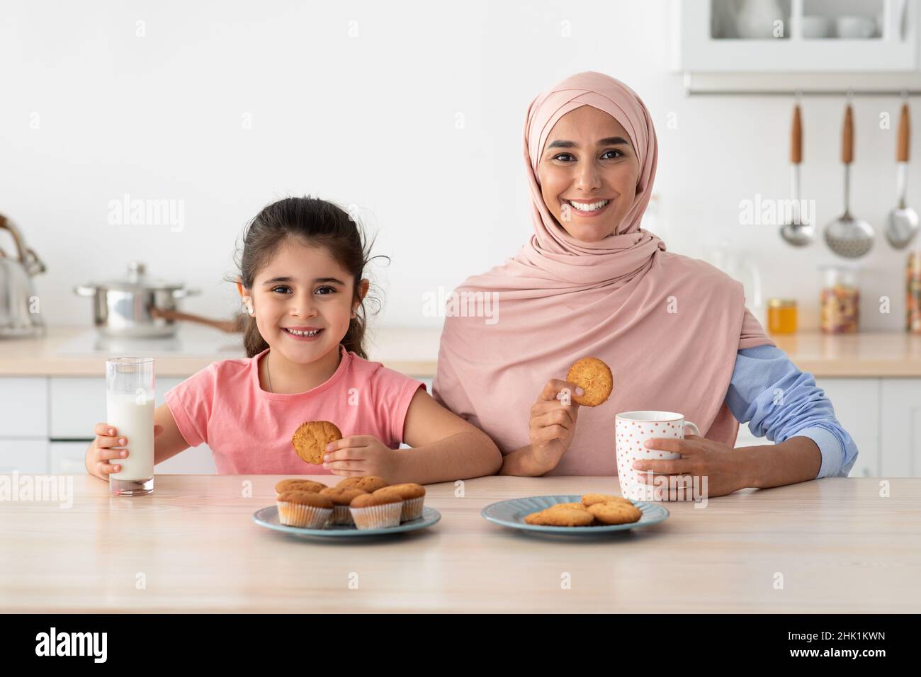 Portrait Of Happy Arabic Family Mom And Daughter Easting Snacks In ...