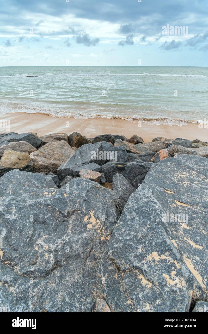 Landscape of a path of rocks in front of the beach, sand strip the ...