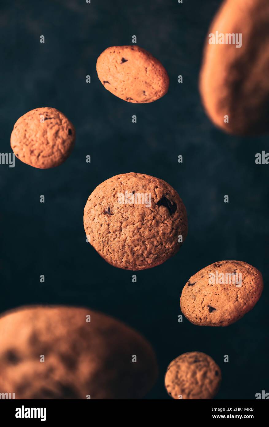 Floating chocolate cookies with dark background Stock Photo - Alamy