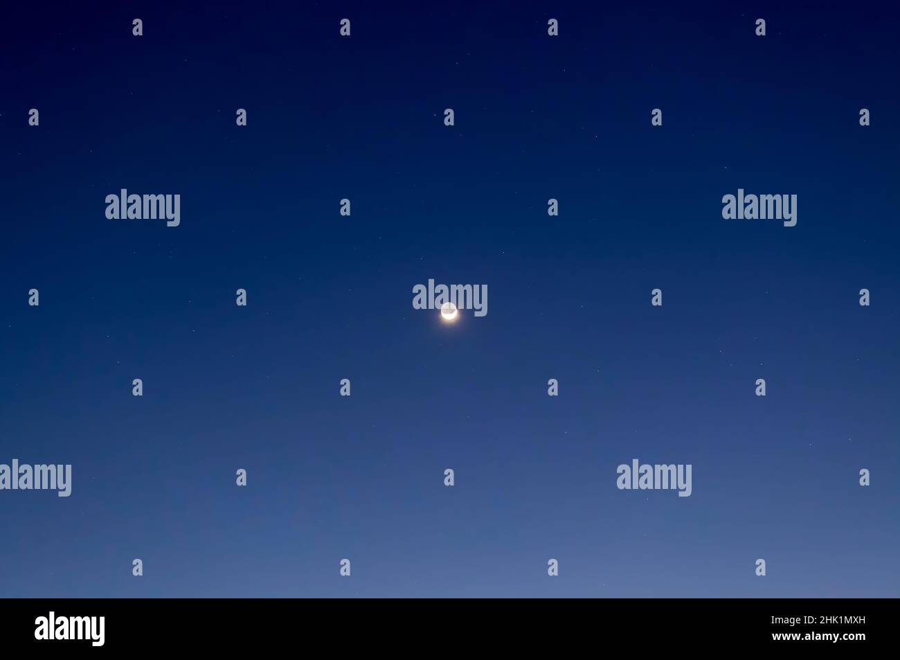 Crescent Moon over Blue Dusk Sky Stock Photo - Alamy