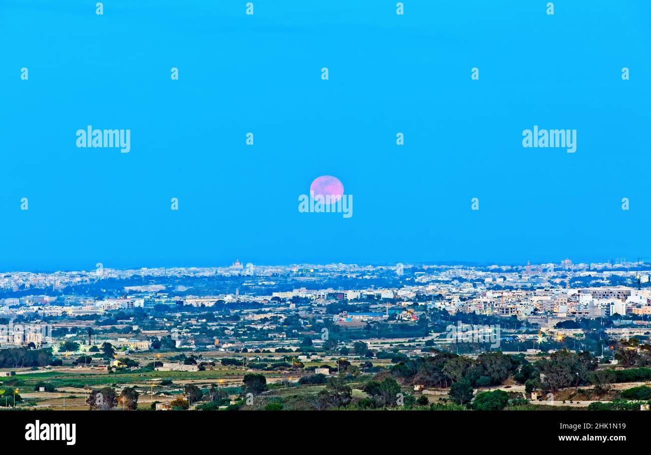 Faint Blood Moon Rising over Maltese Landscape Stock Photo - Alamy