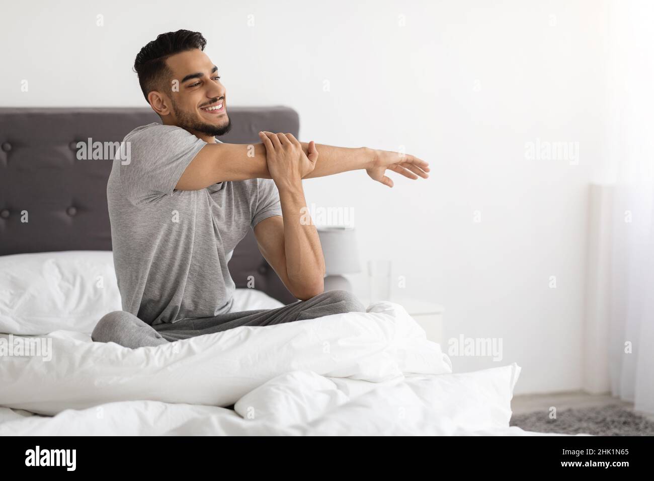Middle Eastern Guy Waking Up In The Morning And Stretching In Bed Stock ...
