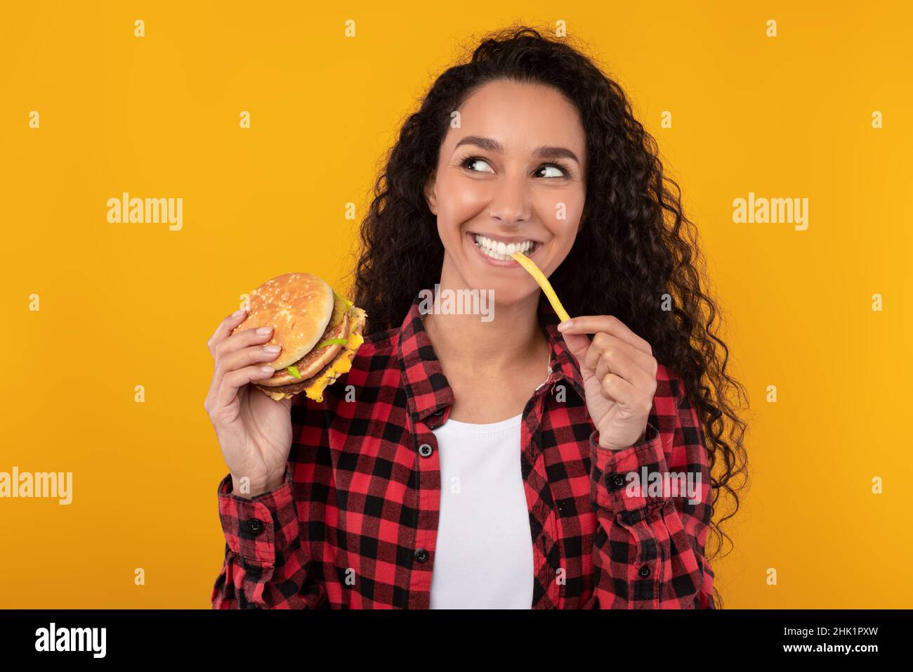 Young woman eating burger model hi-res stock photography and images - Alamy