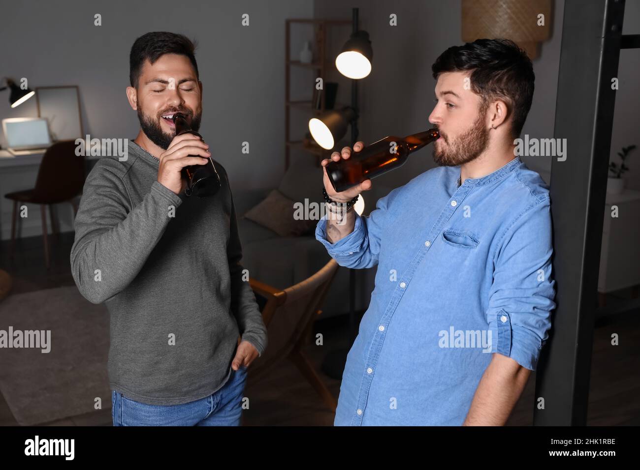 Young brothers drinking beer at home in evening Stock Photo - Alamy