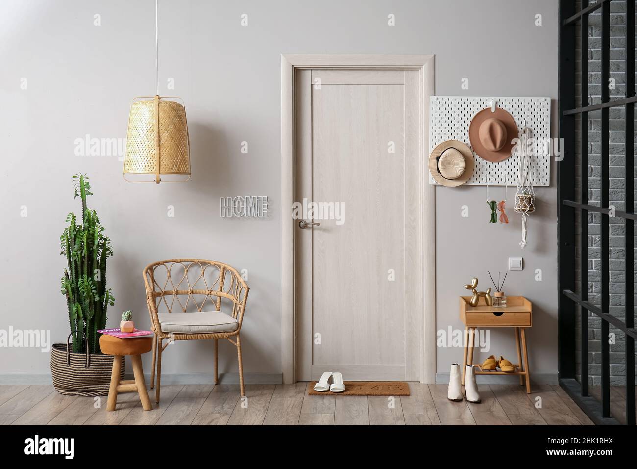 Interior of light hall with armchair, table and accessories Stock Photo ...