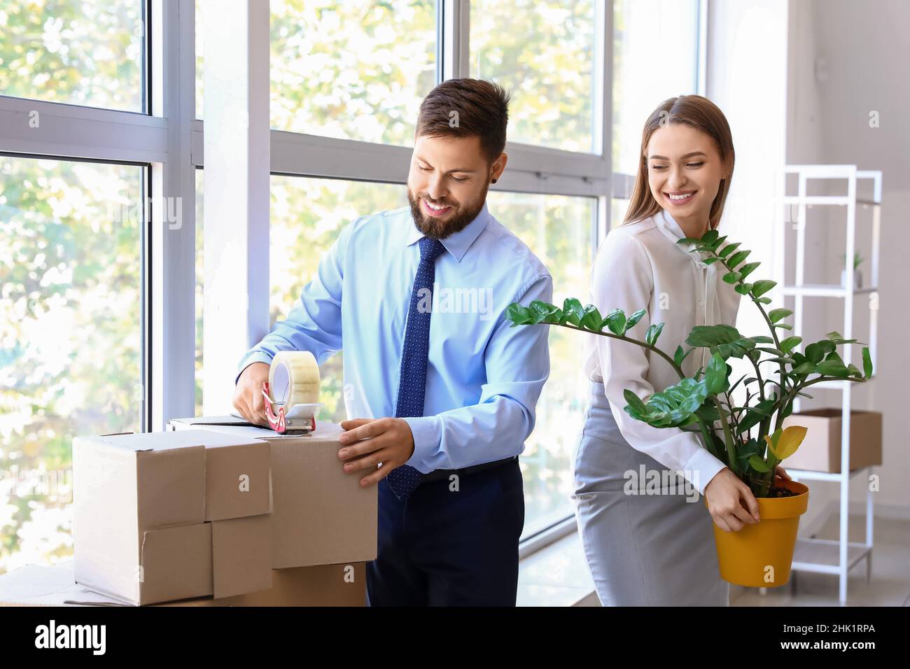 Business colleagues packing things in office on moving day Stock Photo ...
