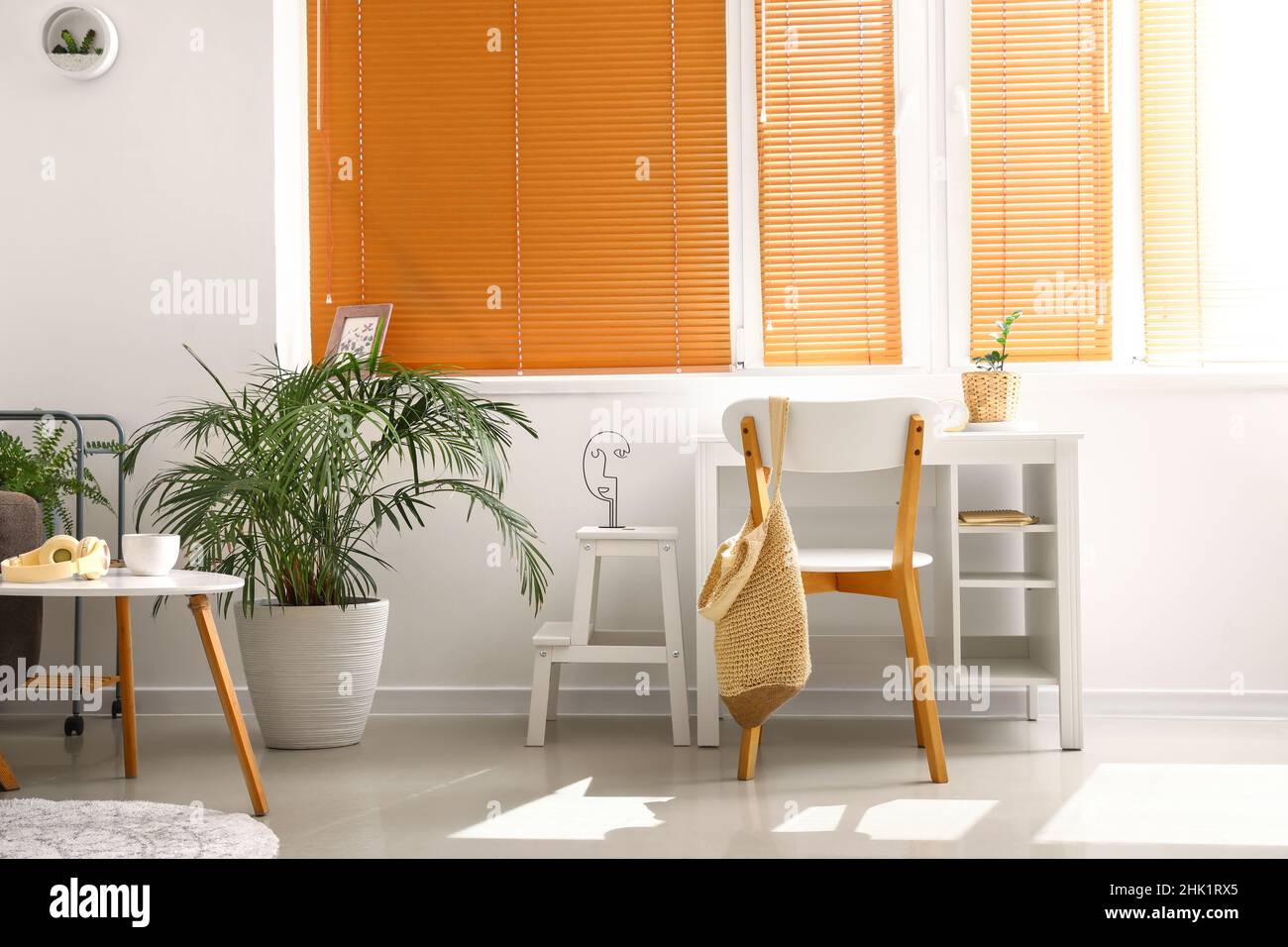 Modern workplace and white step stool near window Stock Photo - Alamy