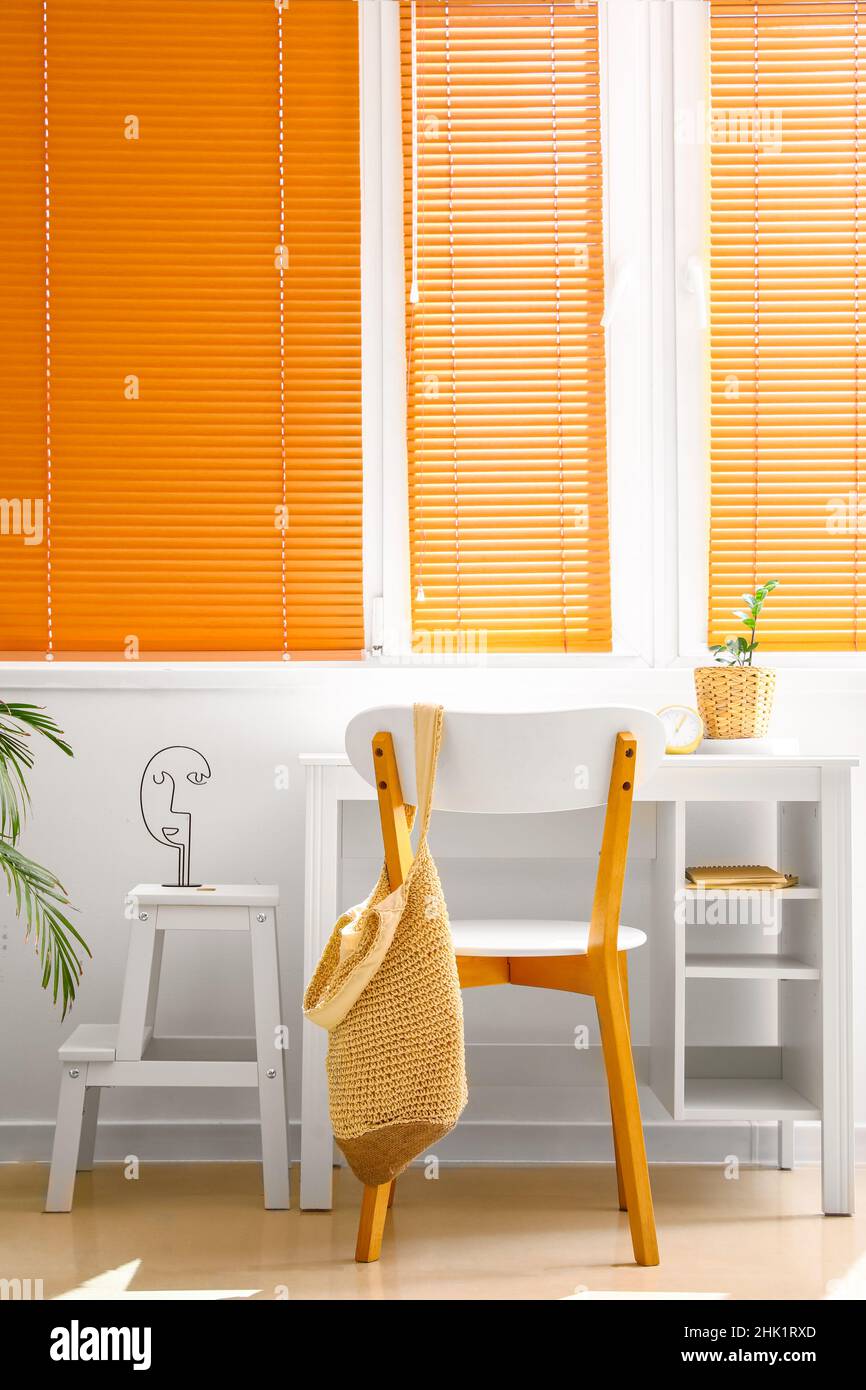 Modern workplace and white step stool near window Stock Photo - Alamy