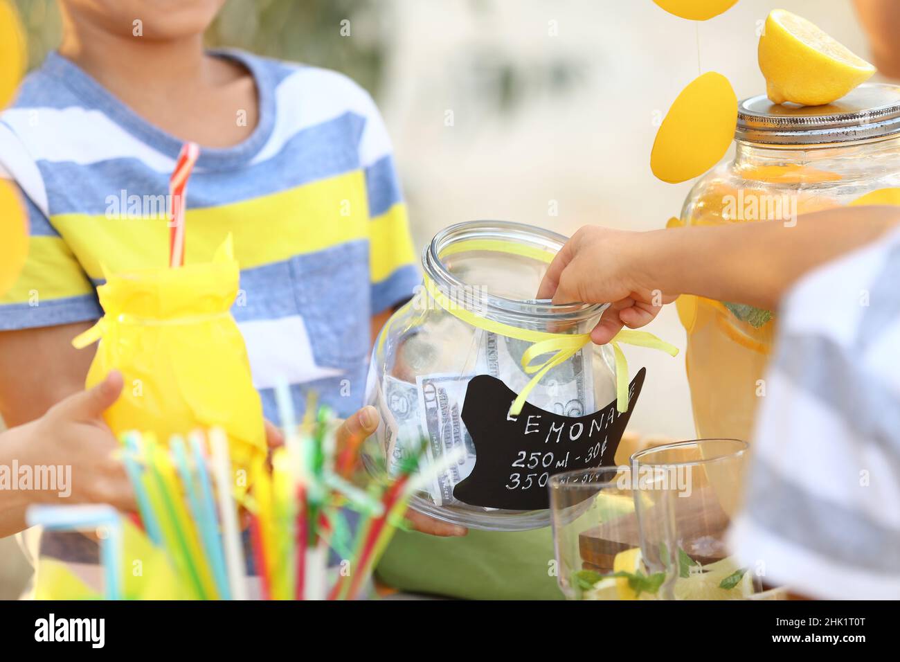 Cute boy selling lemonade in park, closeup Stock Photo - Alamy