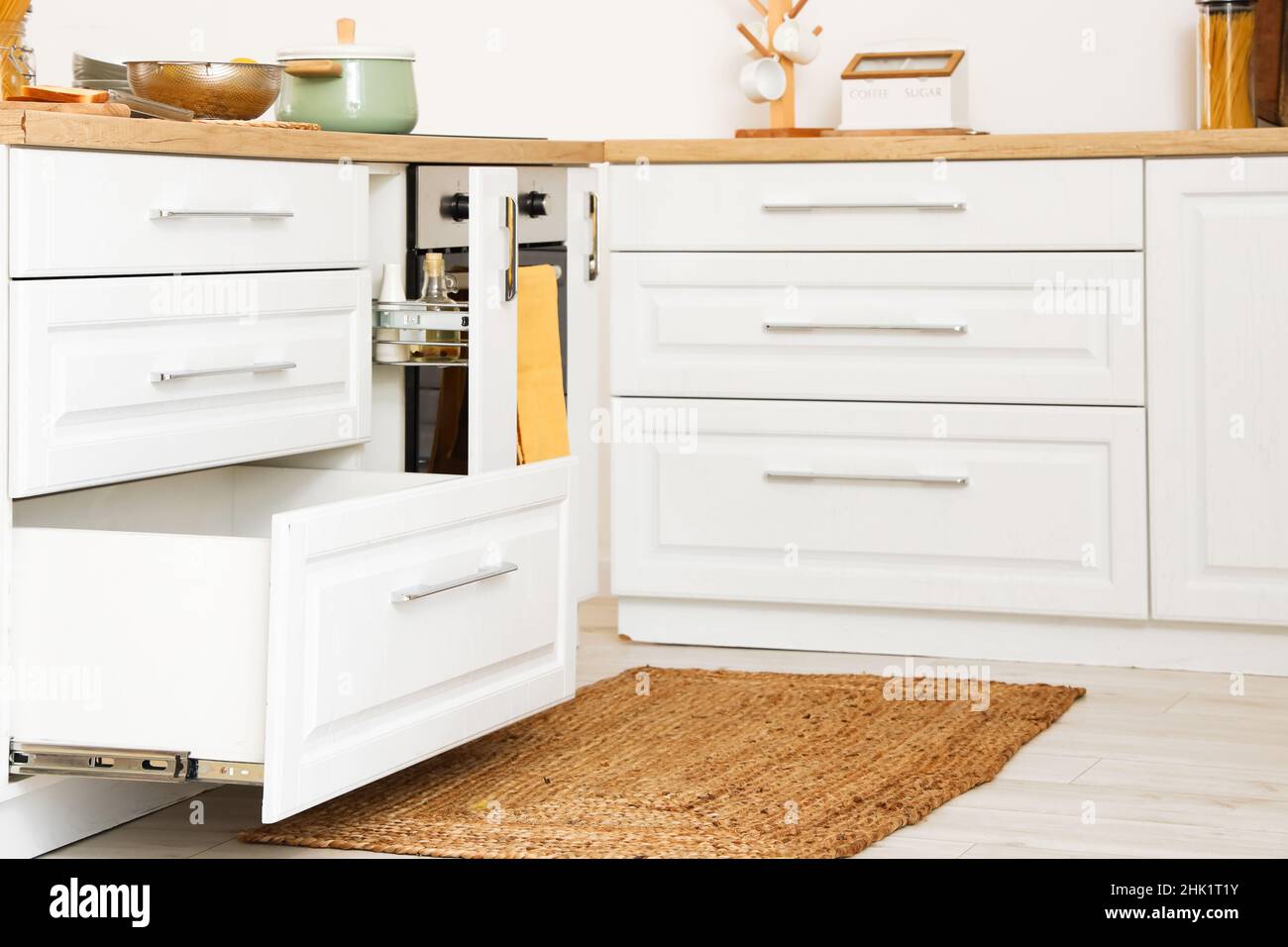 Opened drawers in light kitchen interior Stock Photo - Alamy