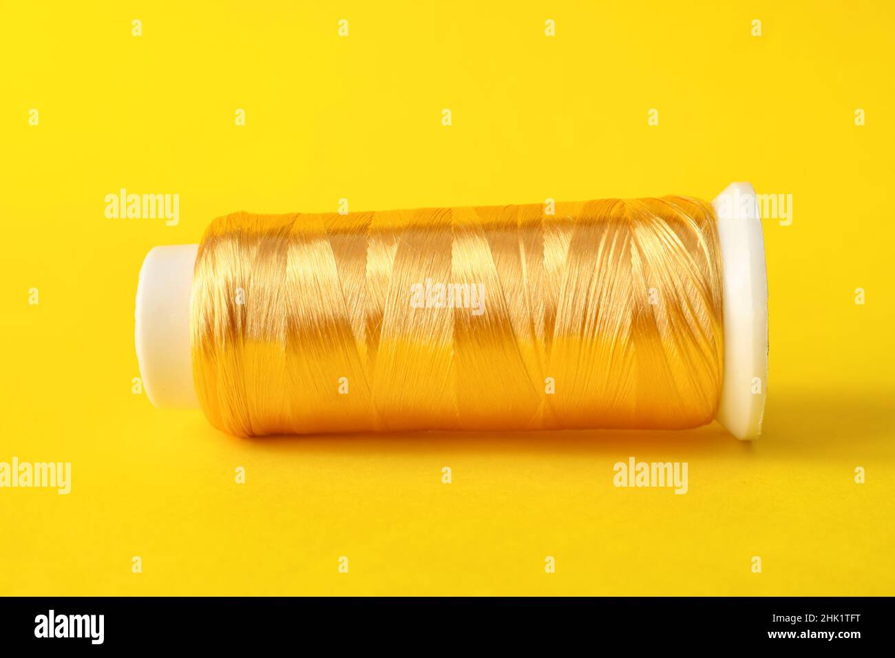 Golden sewing thread spool hi-res stock photography and images - Alamy