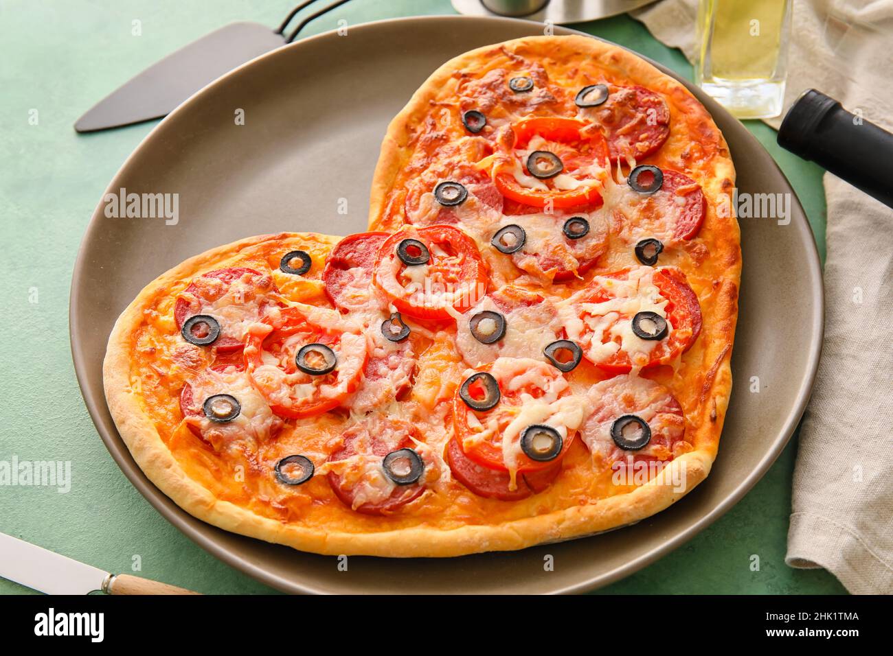Plate with tasty heart-shaped pizza on table. Valentine's Day ...