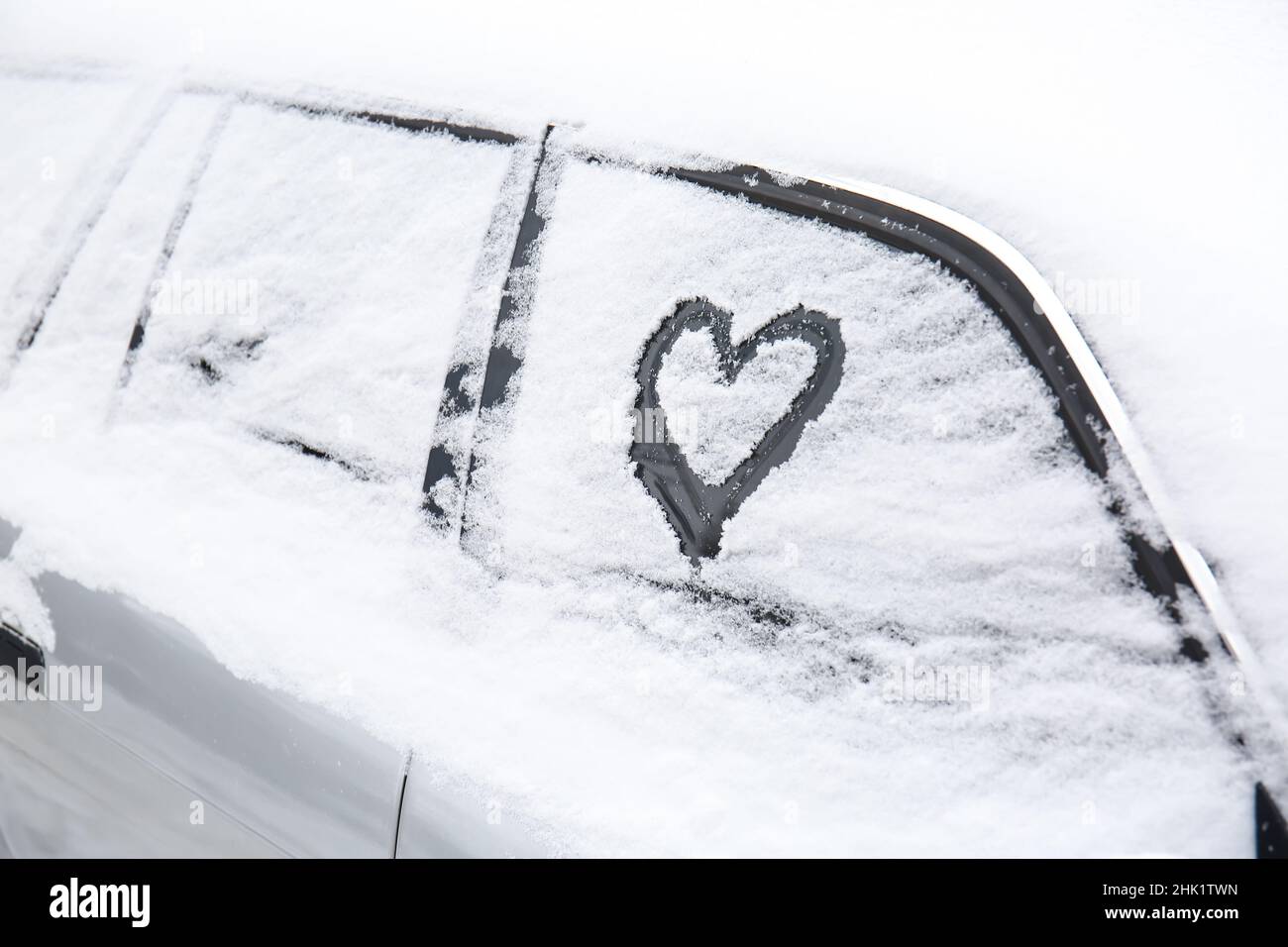 Heart symbol drawn on snow covered car Stock Photo - Alamy