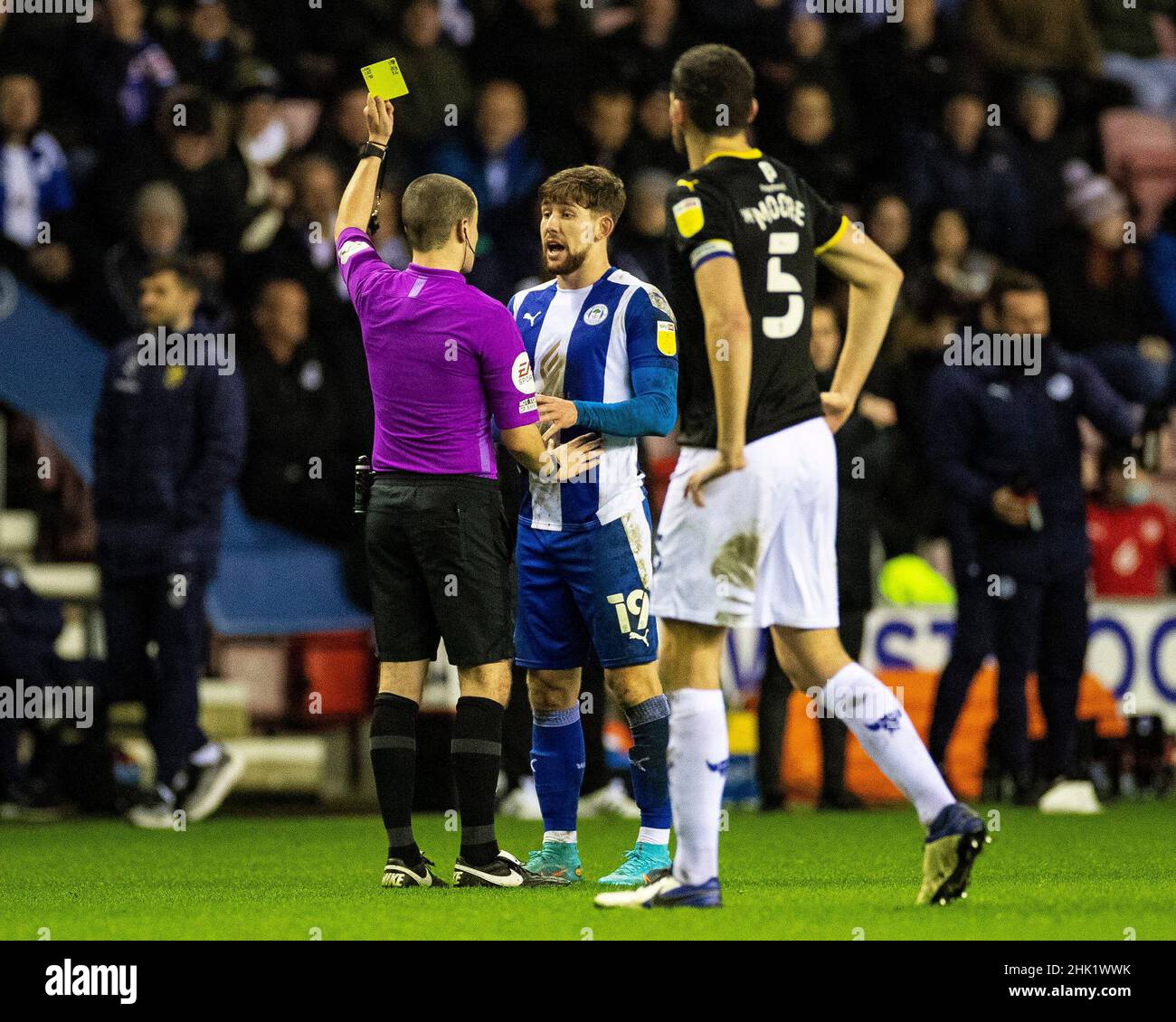 Referee Andrew Kitchen gives yellow card to Callum Lang #19 of Wigan ...