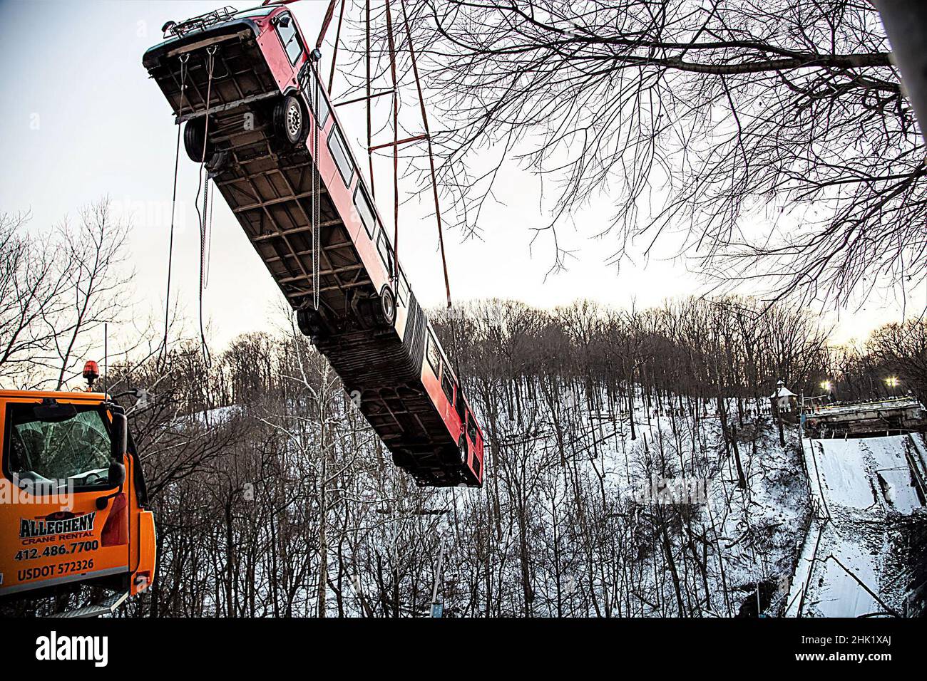 Pittsburgh, Pennsylvania, USA. 1st Feb, 2022. A crane lifts a bus from ...