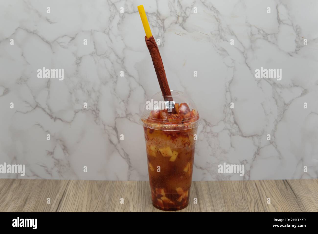 Spicy mango respado fills chunky cup with long and seasoned straw Stock ...