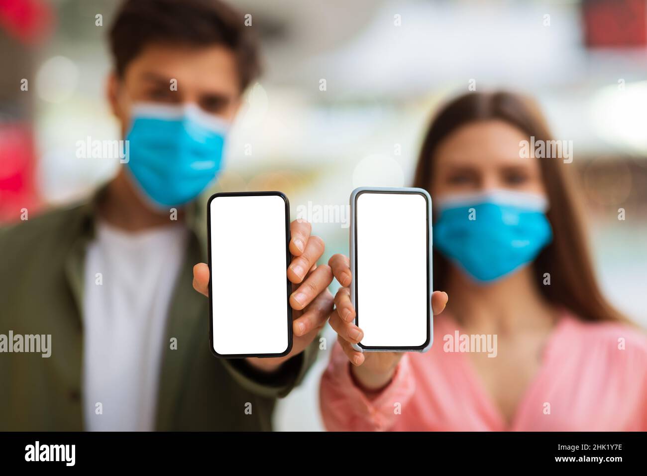 Couple Showing Smartphones Empty Screens Wearing Protective Face Masks ...