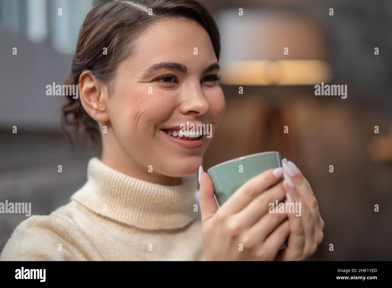 Happy cute lady enjoying her coffee break Stock Photo - Alamy