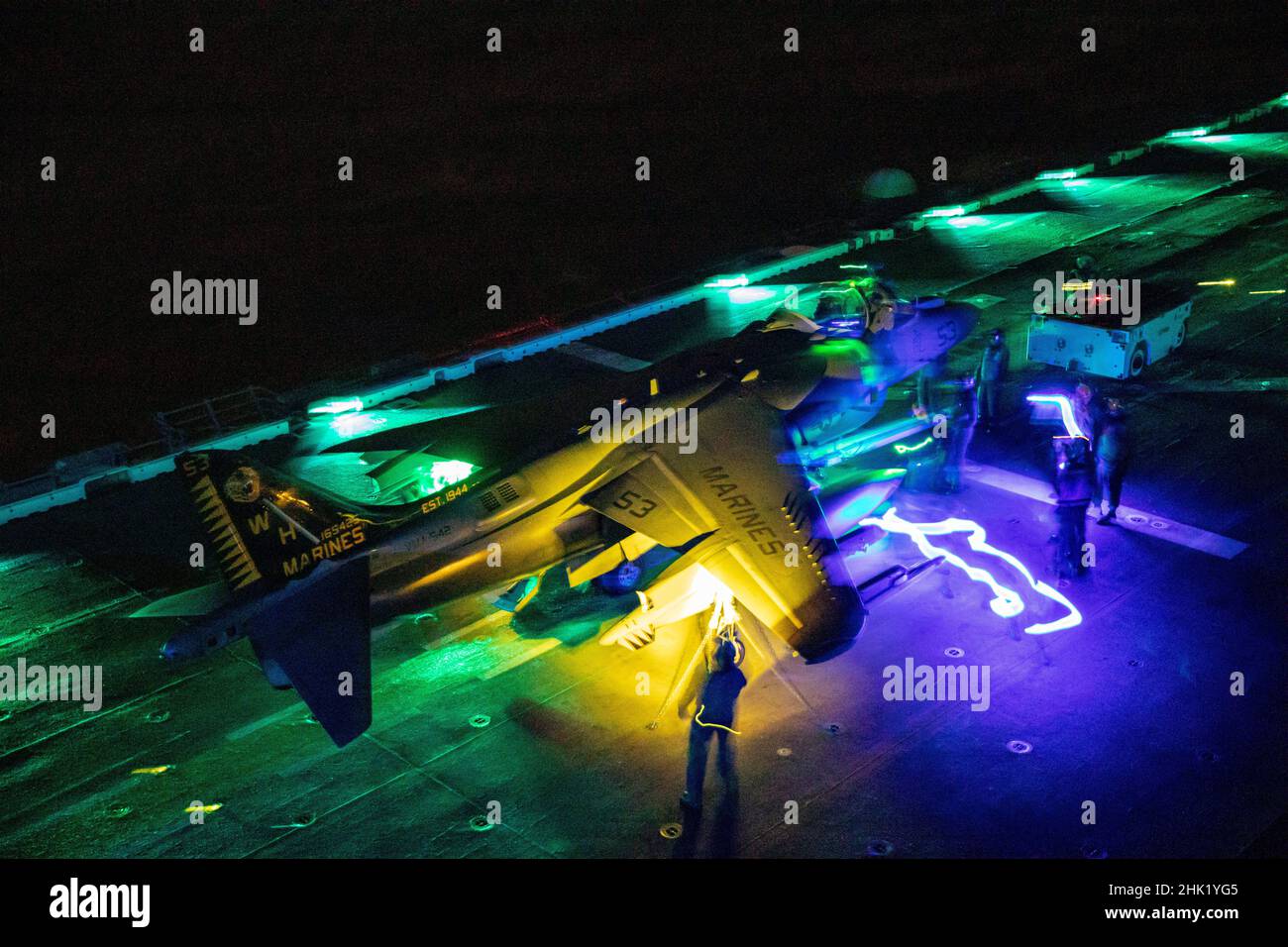 U.S. Navy Sailors conduct post-flight checks on a AV-8B Harrier during ...