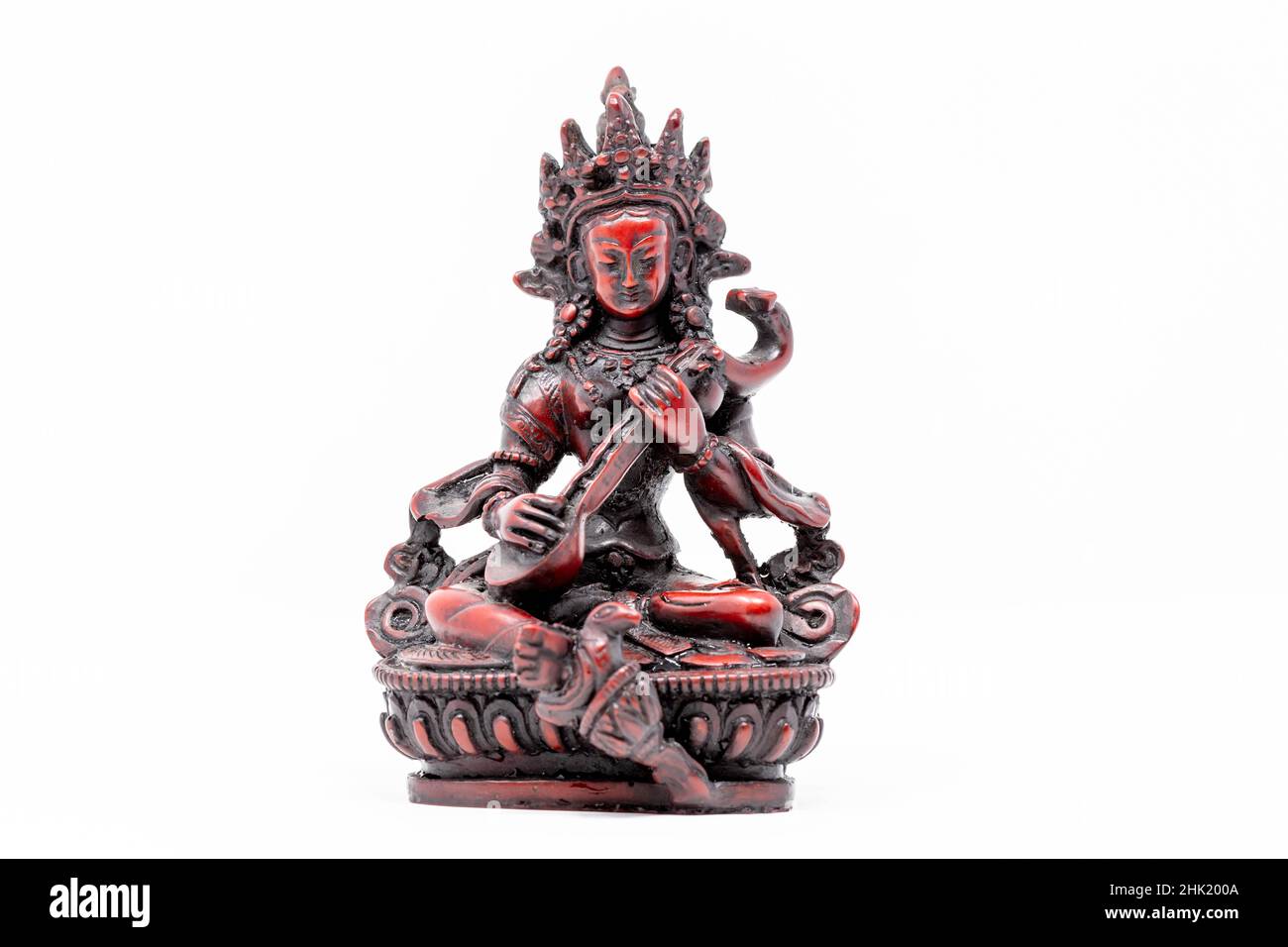 Close up statue of goddess Saraswati with musical instrument isolated ...
