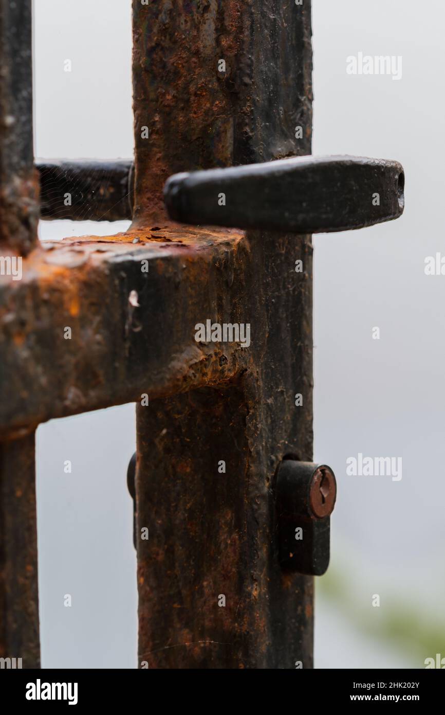 Vertical shot of a rusty old door with a knob outside Stock Photo - Alamy