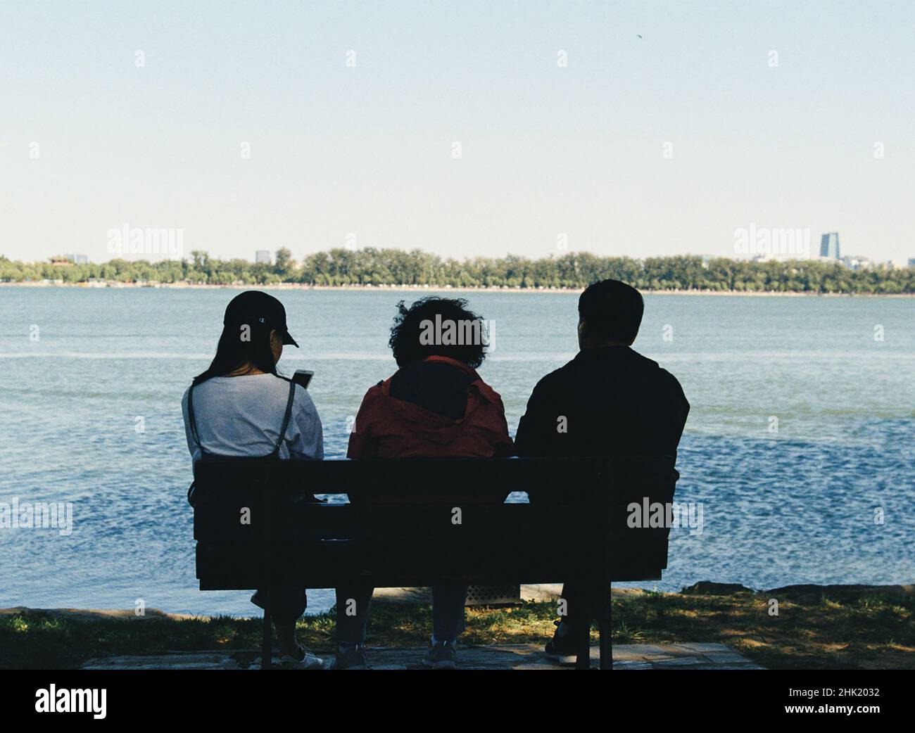 Yung people sitting on a bench near a river in Beijing, China Stock ...