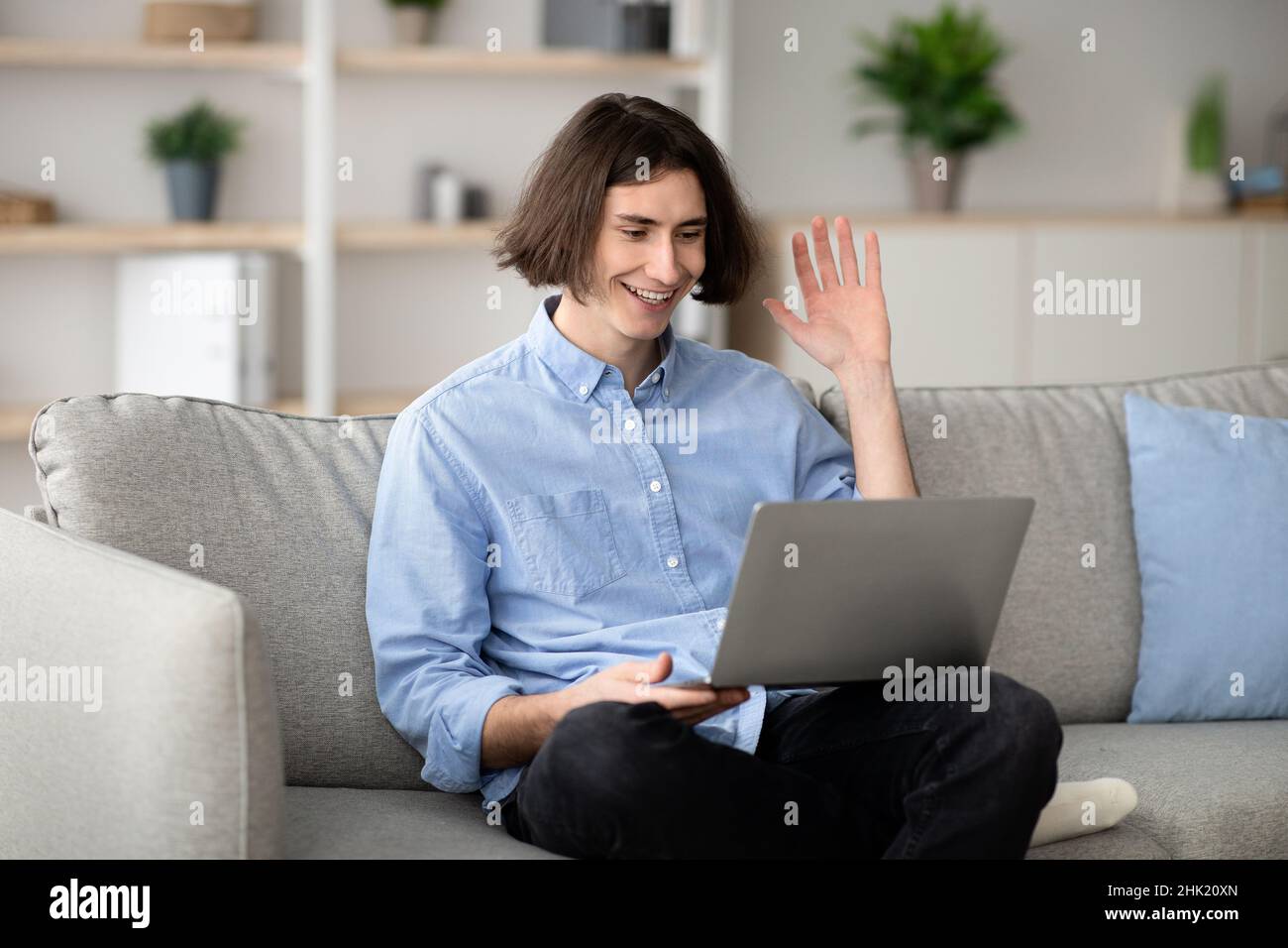 Distant communication concept. Happy man video calling on laptop ...