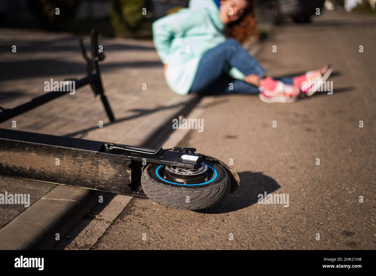 Caucasian woman fell from an electric scooter and suffers from pain ...