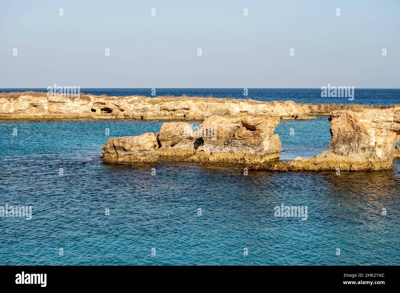Crystal clear blue water of Mediterranean sea and yellow rocks in ...