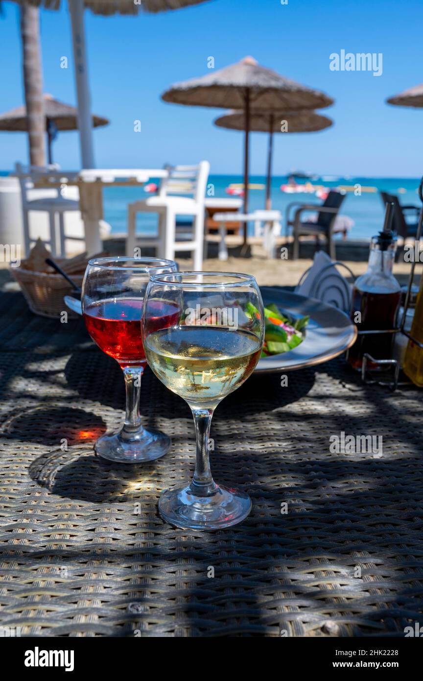 Drinking of cold rose and white wines in lounge bar on sunny sandy ...