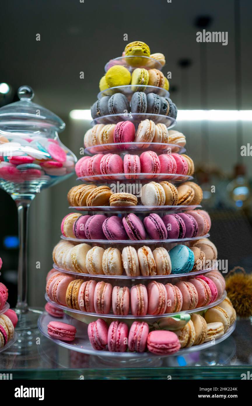 Candy shop display with colorful pyramid of French macarons biscuits at ...
